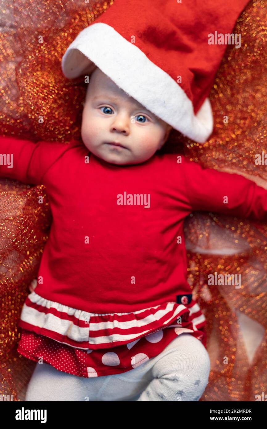 Little baby in a festive red Santa outfit Stock Photo - Alamy