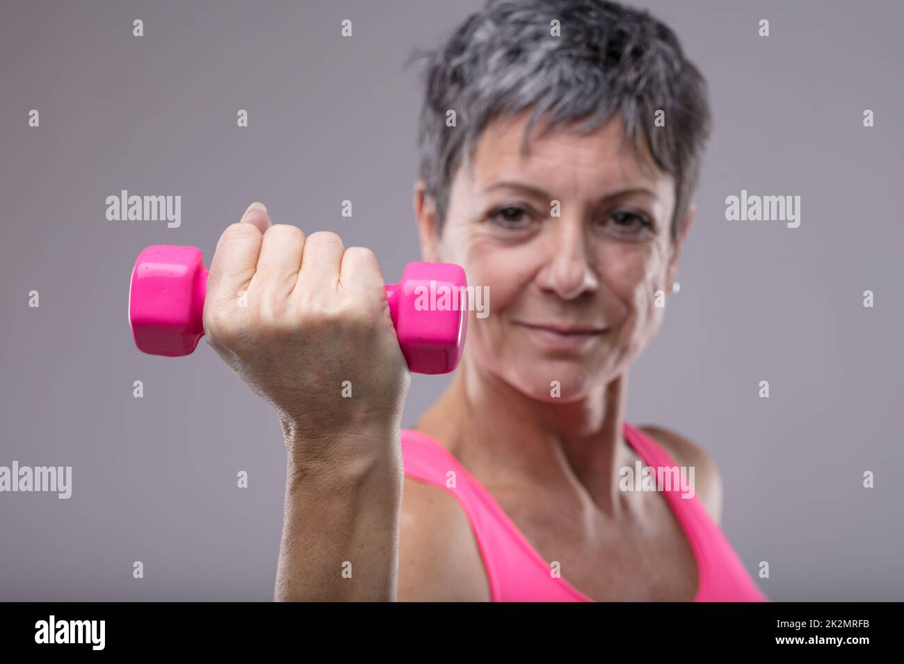 Fit determined woman working out with weights Stock Photo - Alamy