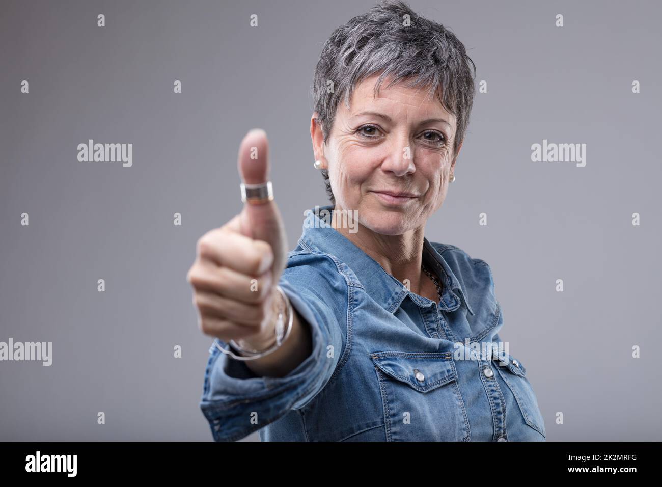 Smiling middle-aged woman giving a thumbs up Stock Photo - Alamy Smiling middle-aged woman giving a thumbs up Stock Photo - Alamy
