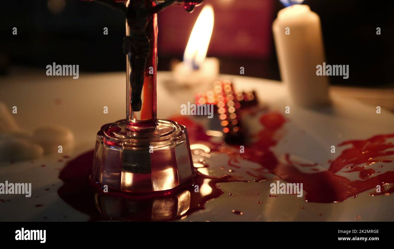Close up of cross of jesus with blood lit by candle Stock Photo - Alamy