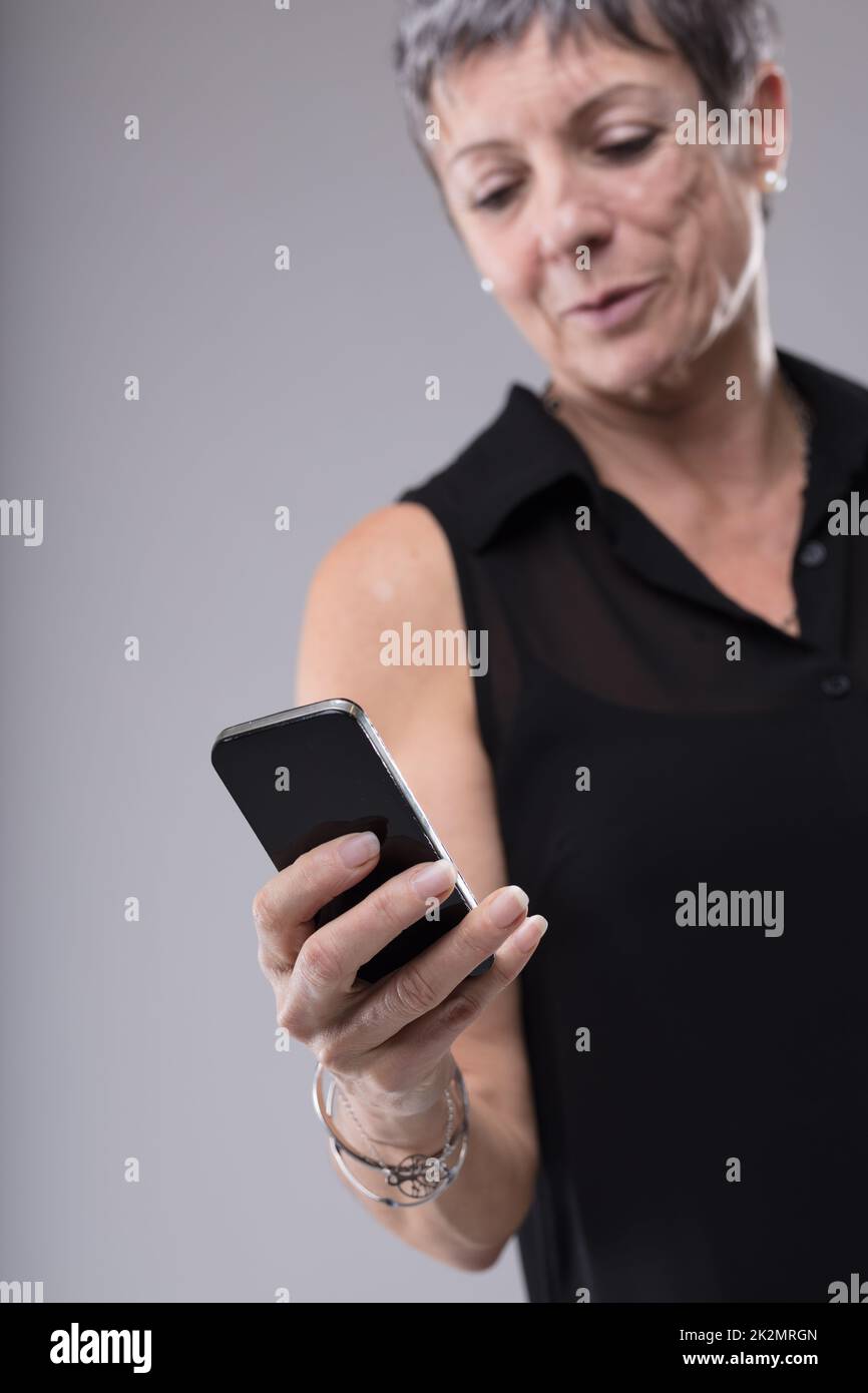 Amused woman reading a text message Stock Photo - Alamy