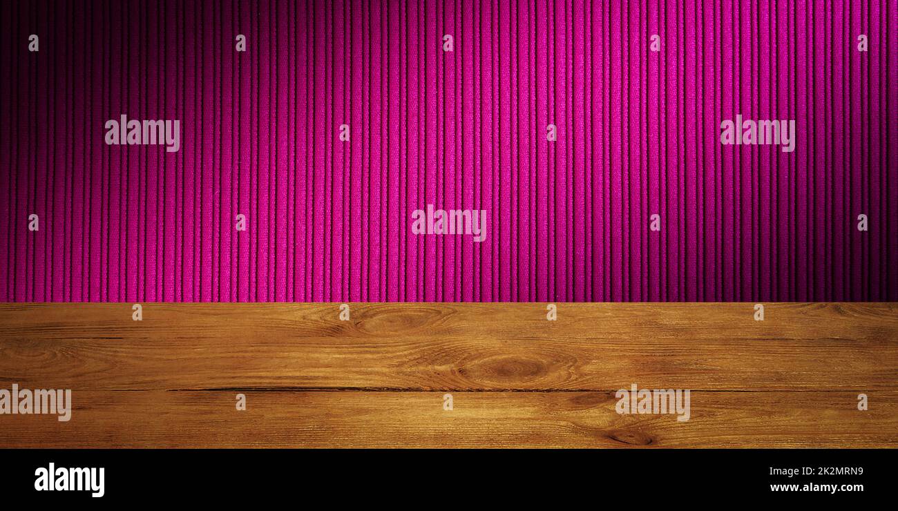 The background is blank wooden boards and a textured striped wall with ...