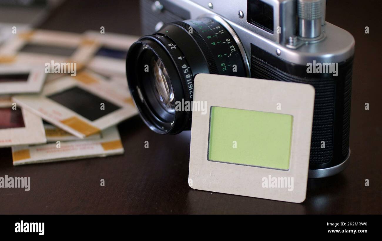 Vintage film camera and slide film Stock Photo - Alamy