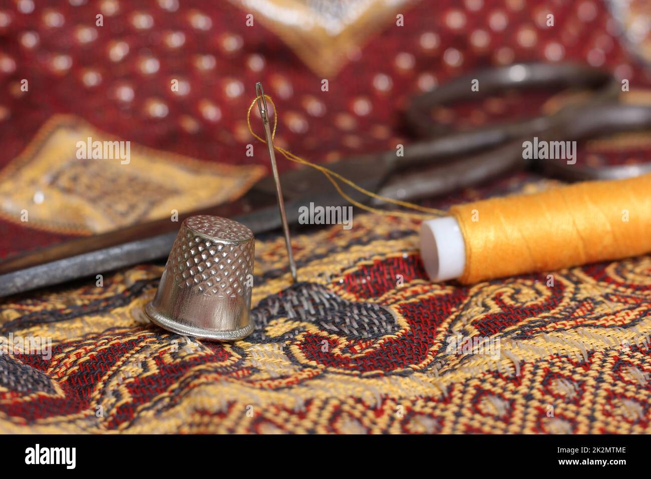 Golden Thread and Thimble on Vintage Fabric From The Middle East Stock ...