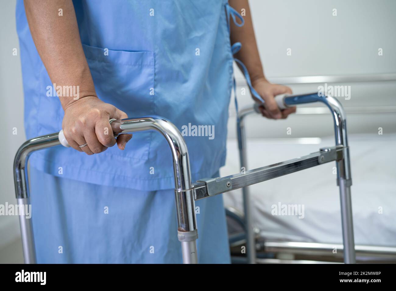 Asian lady woman patient walk with walker at nursing hospital ward ...
