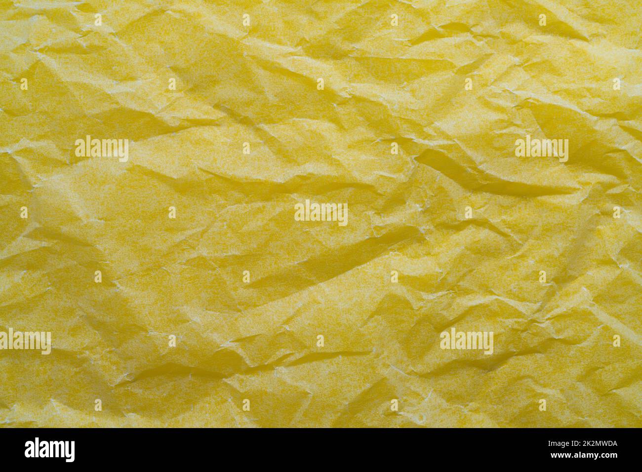 crumpled paper on a yellow surface Stock Photo - Alamy