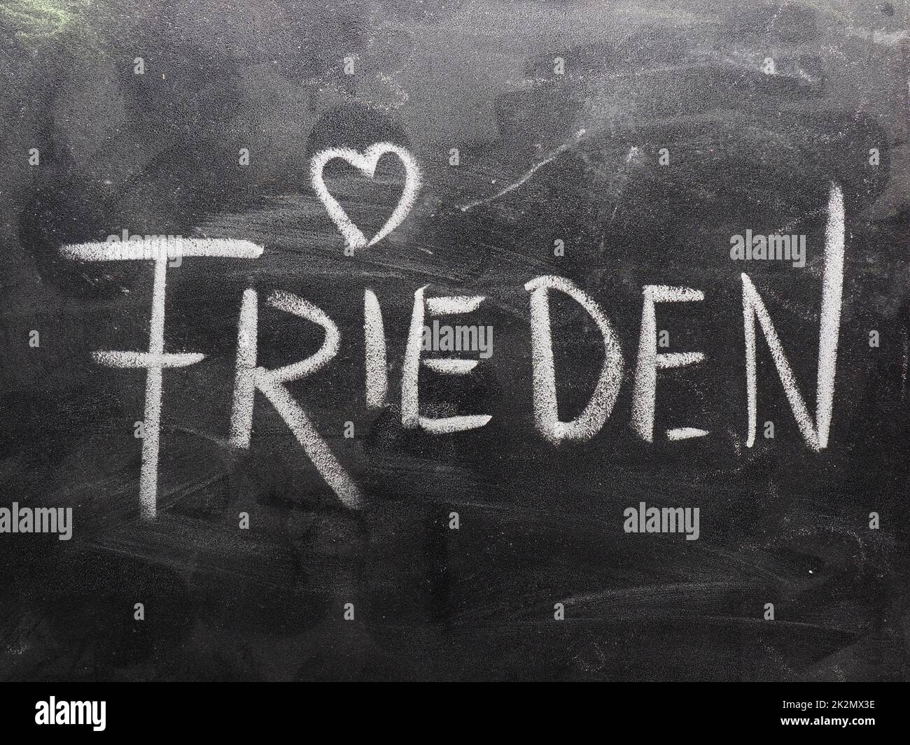 The German word peace with a heart shape on a chalkboard Stock Photo ...