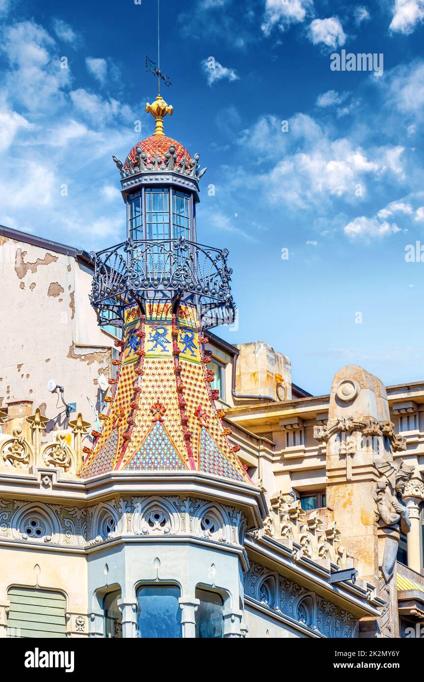 Architectural detail of a small tower with multi-coloured tiles on the ...
