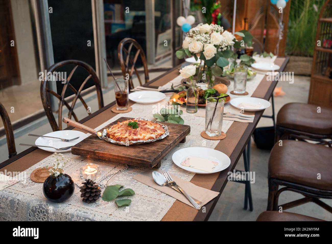 Antique dining table with pizza, salad, crockery and object decoration ...