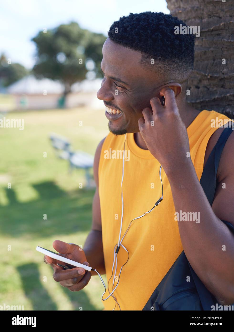 African american man using smartphone listening to music relaxing ...