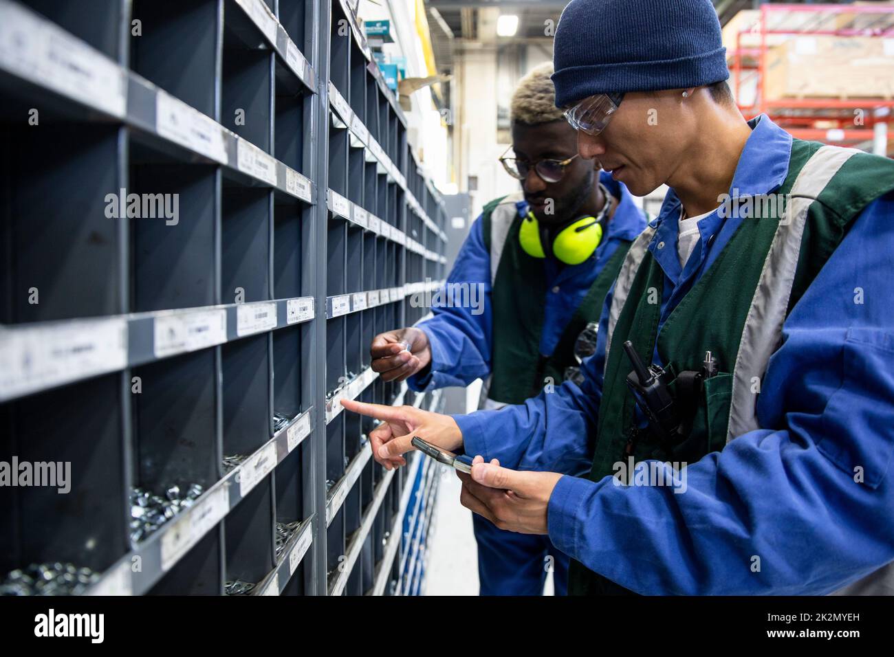 Male transit workers looking for parts in maintenance facility Stock ...