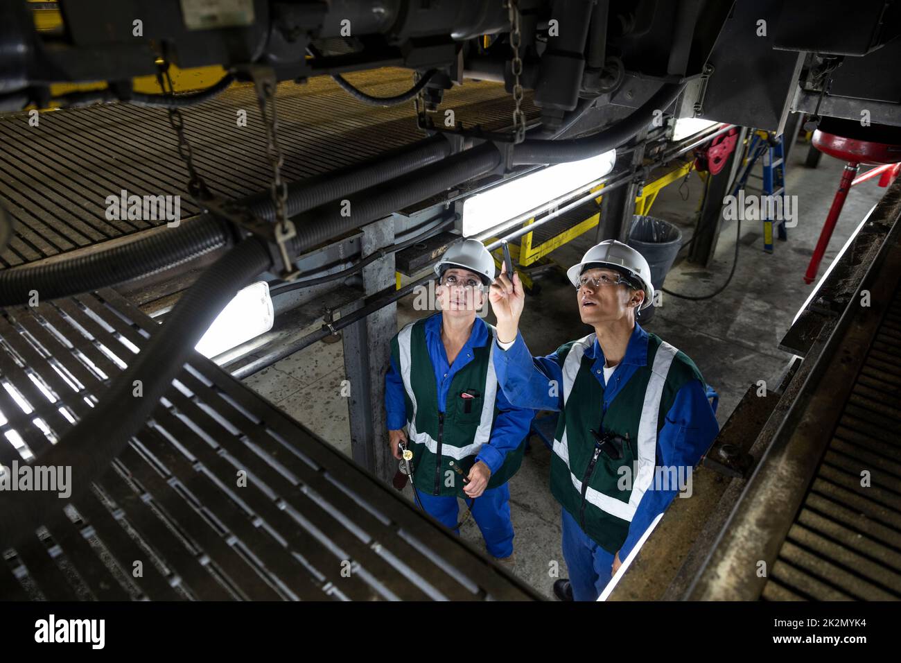 Transit workers below subway in maintenance facility Stock Photo - Alamy