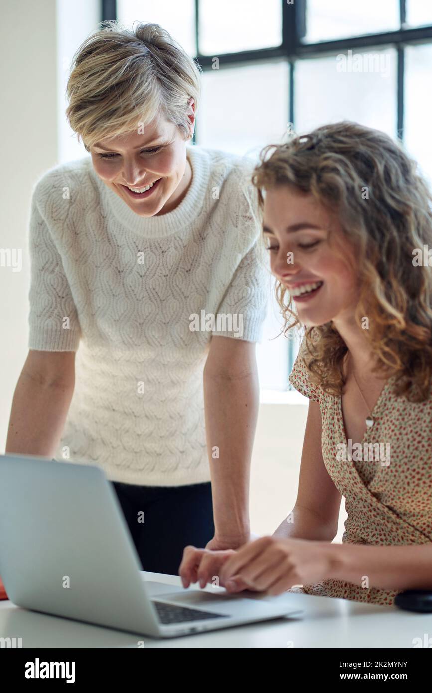 two business women using laptop computer working in office team leader ...