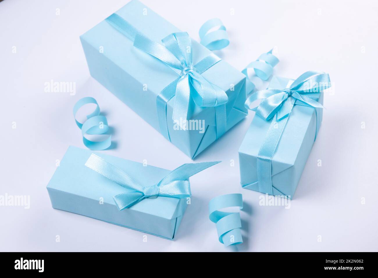 blue gift boxes with blue bows on a blue background, top view, the ...