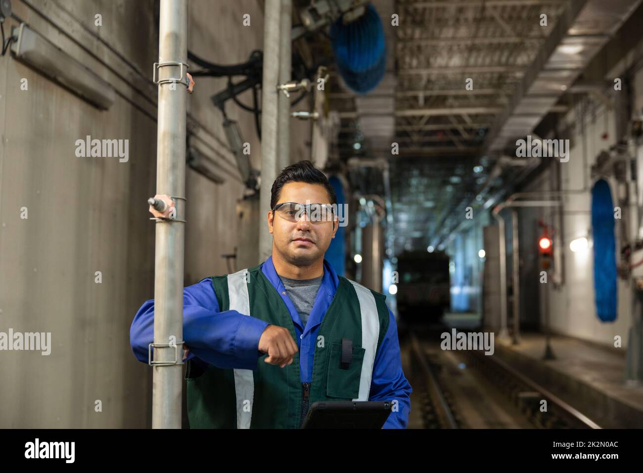 Portrait confident male transit worker in maintenance facility Stock ...