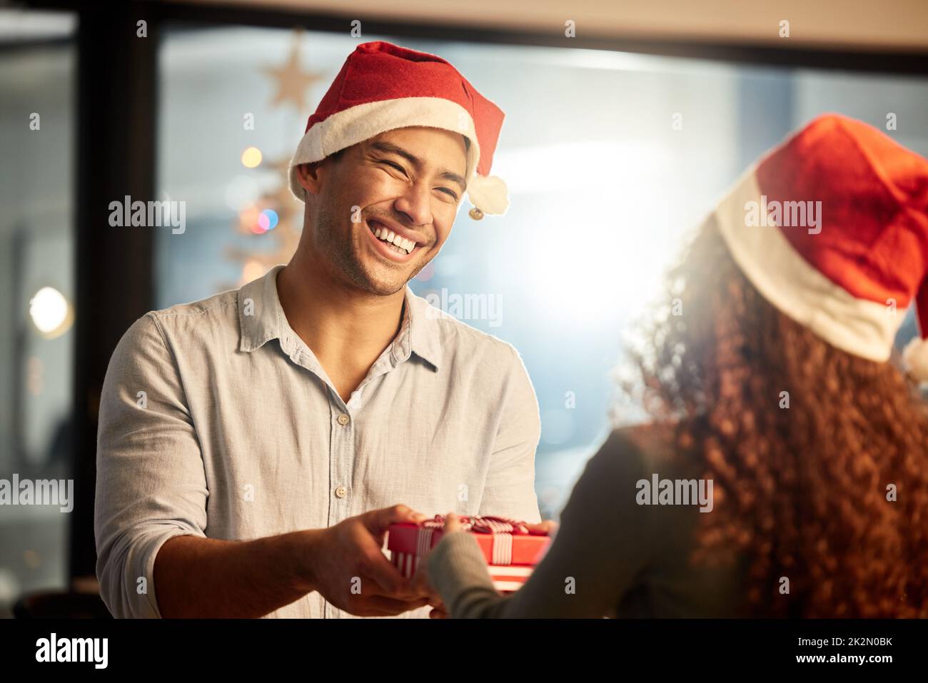 Christmas is a time for giving. Shot of two young businesspeople ...