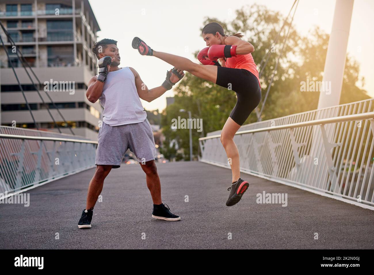 Working on her kicks. Shot of a young couple going through some ...