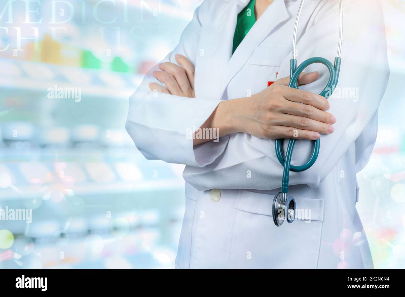 Doctor wears white uniform. Physician stand with arms crossed and hand ...