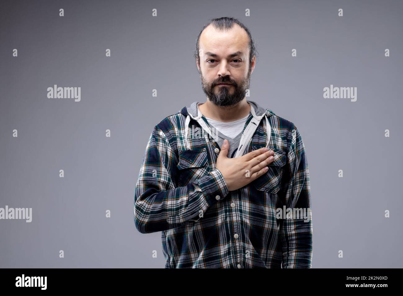 Patriotic or sincere man placing hand on heart Stock Photo - Alamy
