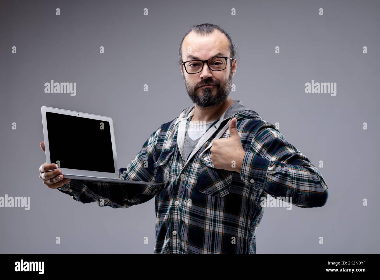 Successful pleased man giving a thumbs up Stock Photo - Alamy
