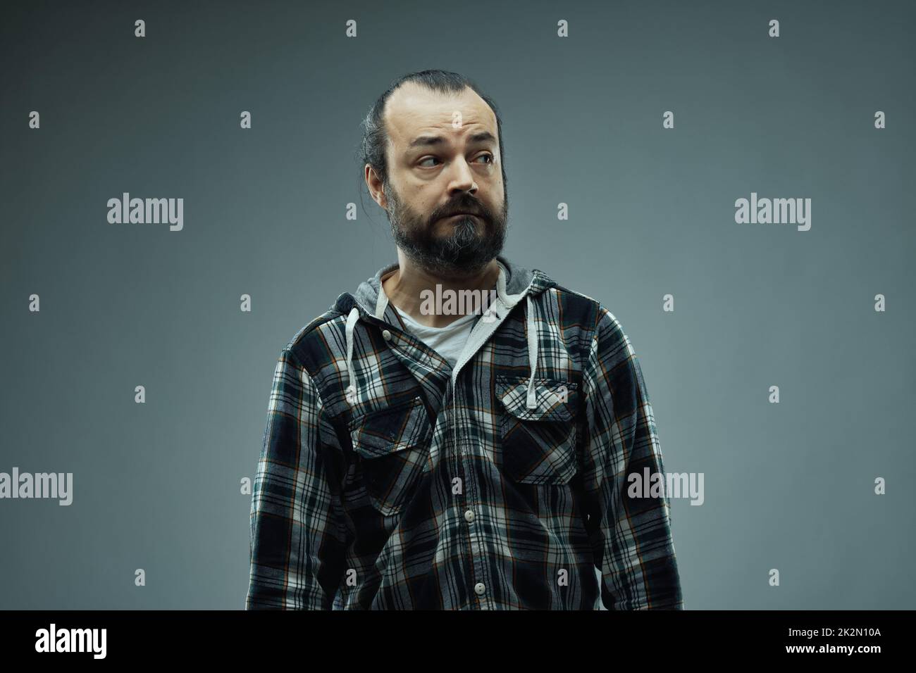 Portrait of a hipster man looking to the right with suspicion Stock ...