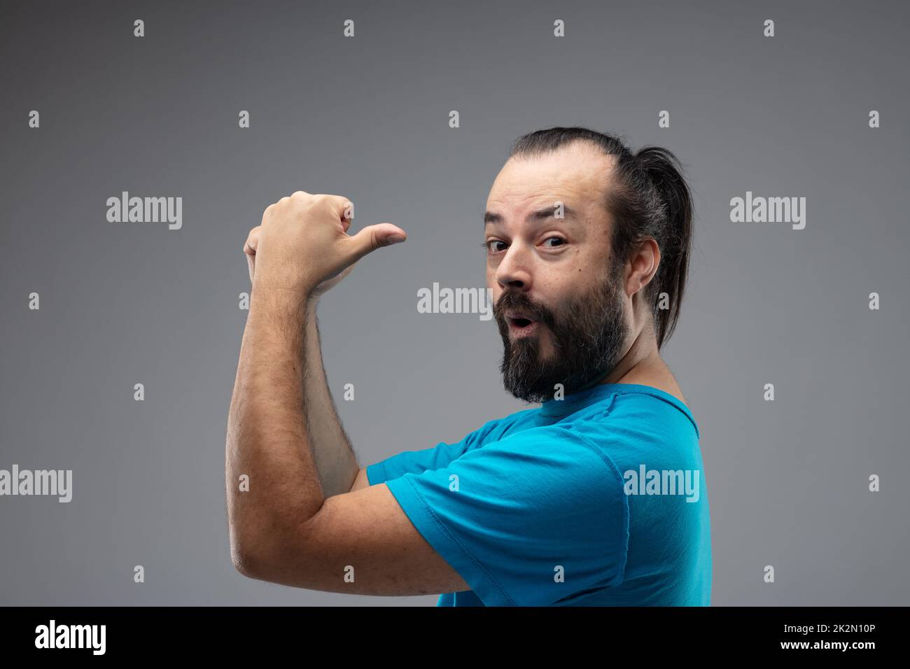 Bearded man with his arms up and thumbs up Stock Photo - Alamy