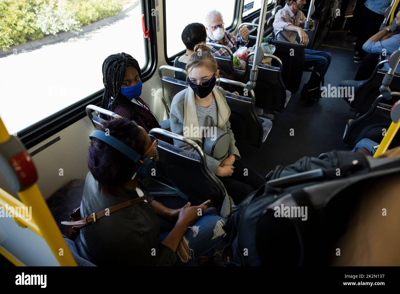 Face masks on bus hi-res stock photography and images - Alamy