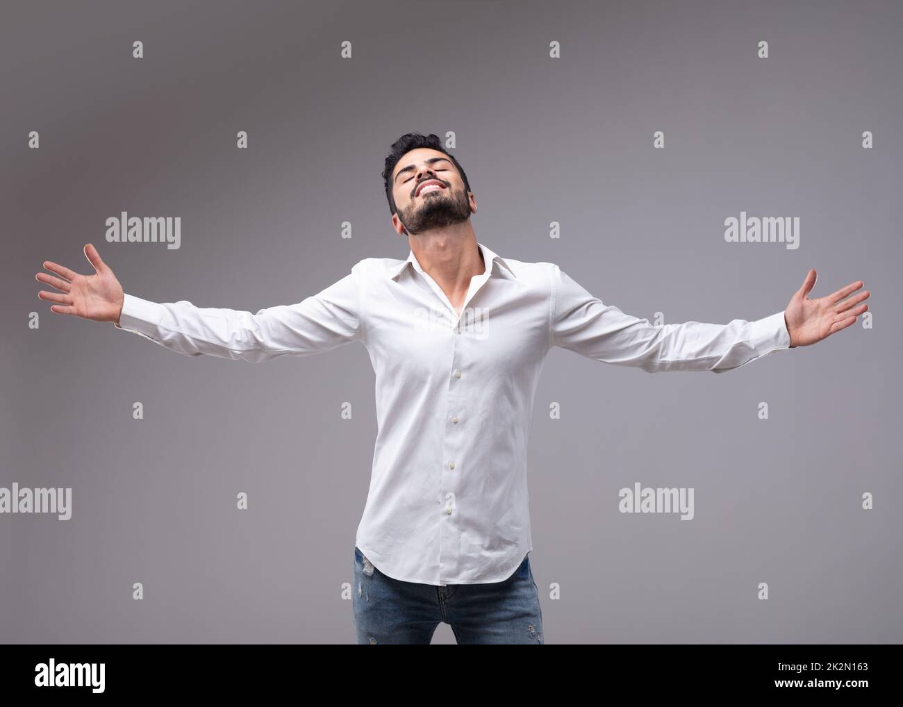 Man showing relieved gesture with spread arms Stock Photo - Alamy