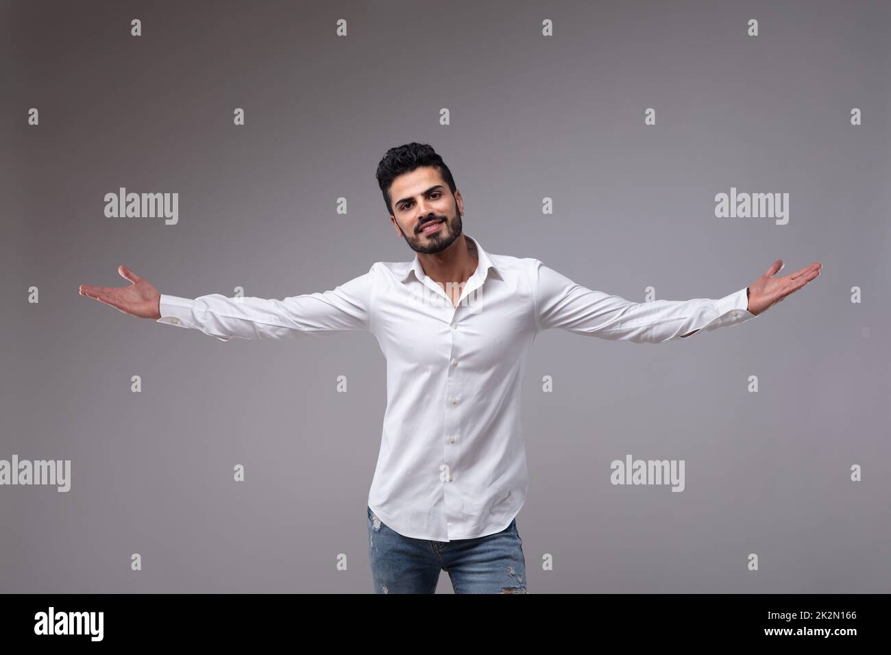 Portrait of young man with outstretched arms Stock Photo - Alamy
