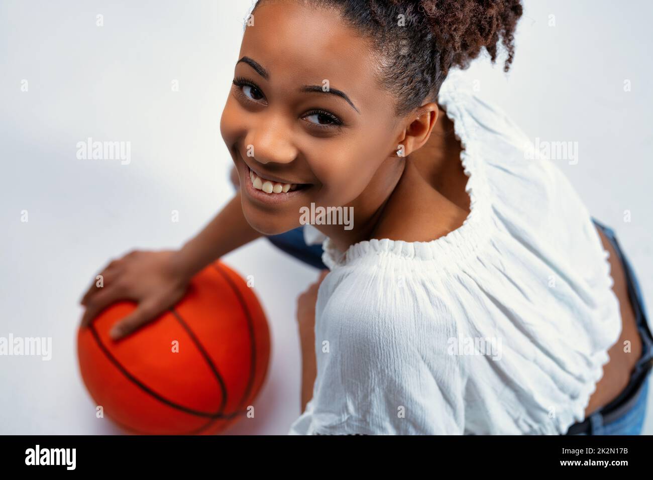 Friendly happy young Black woman smiling up at the camera Stock Photo ... Friendly happy young Black woman smiling up at the camera Stock Photo ...
