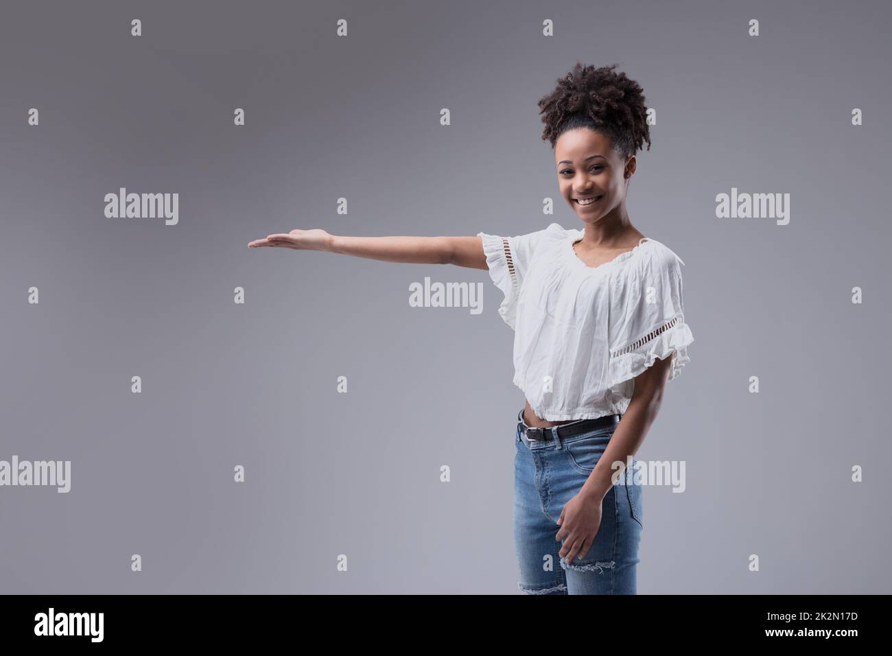 Black girl holding out her empty palm for product placement Stock Photo ...