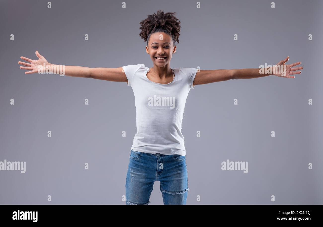 Joyful exuberant young woman grinning happily at the camera Stock Photo ...