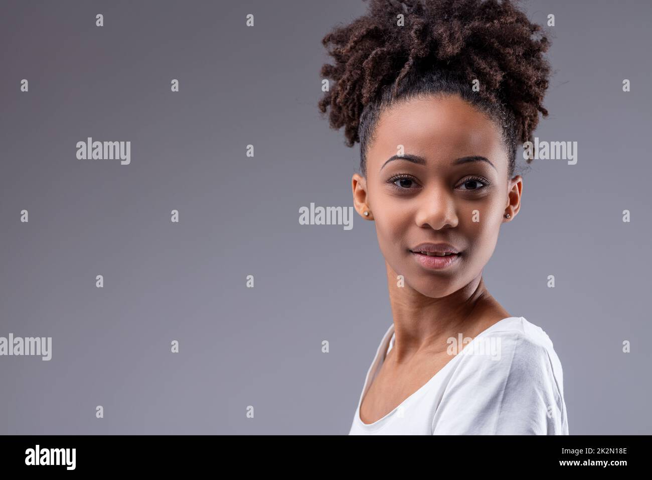 Young Black woman turning to look at the camera Stock Photo - Alamy