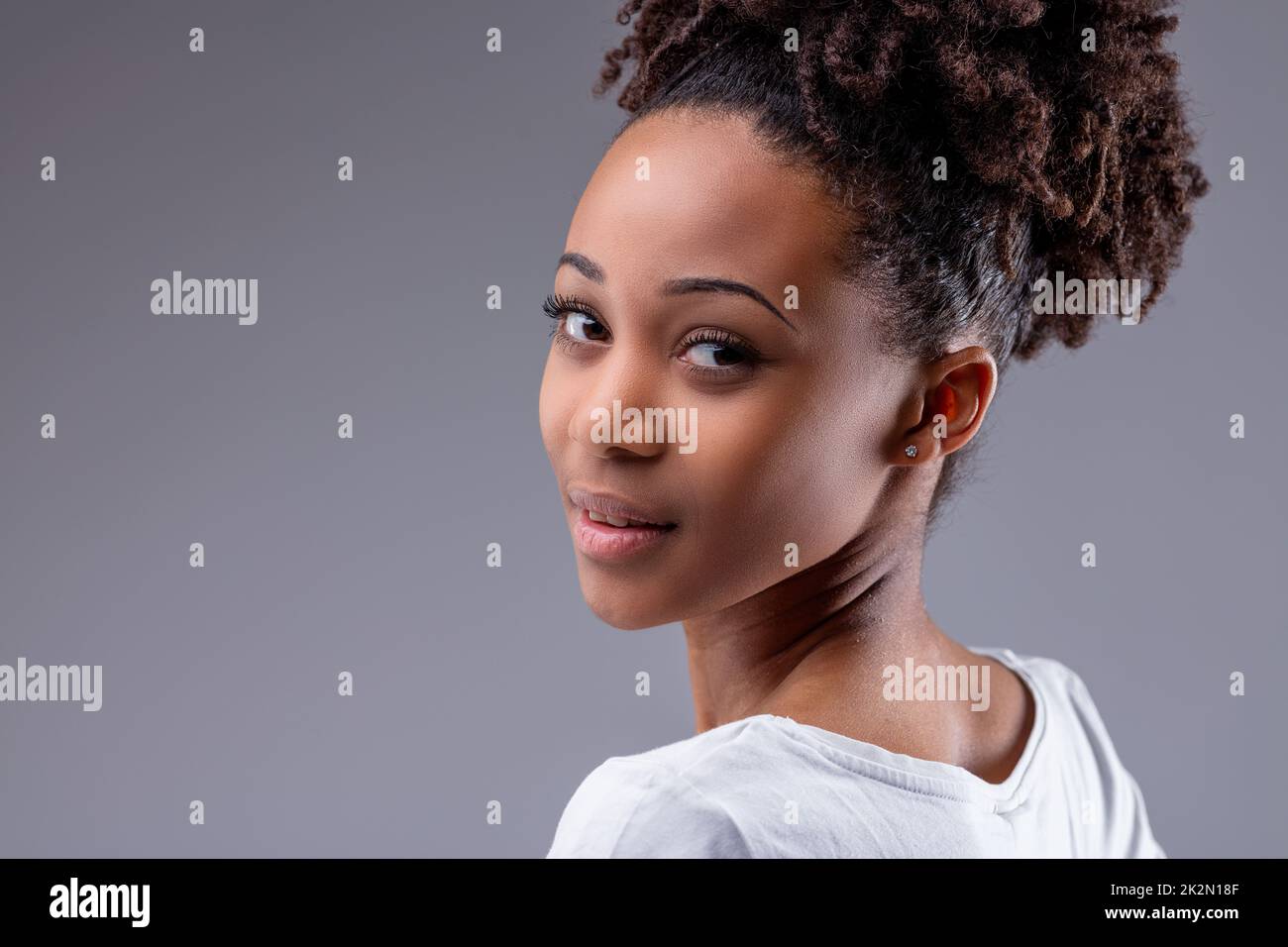 Pretty young Black teenager looking back over her shoulder Stock Photo ...