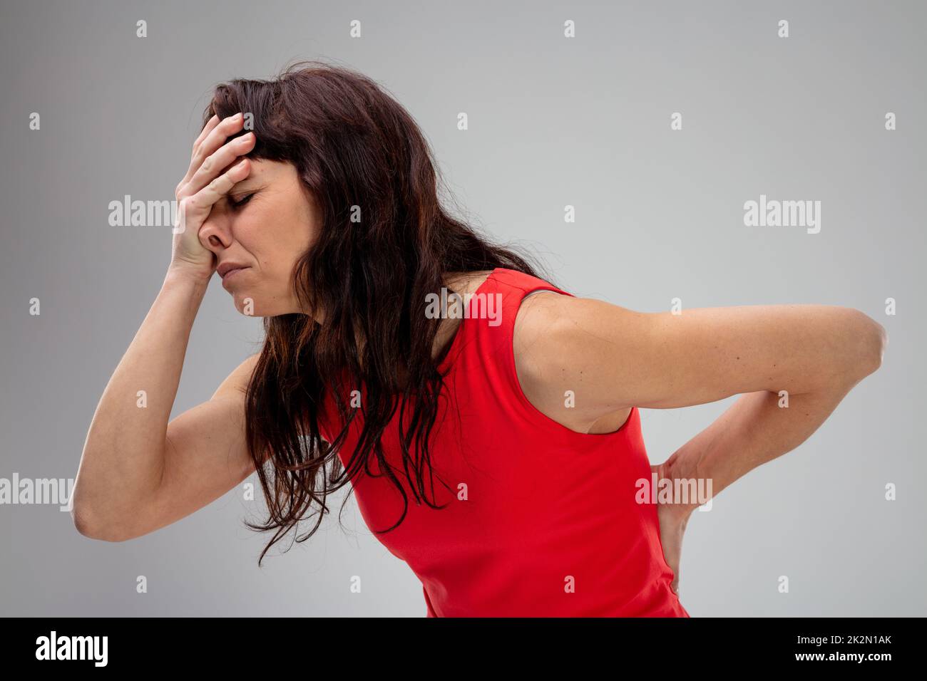 Miserable woman with backache Stock Photo - Alamy