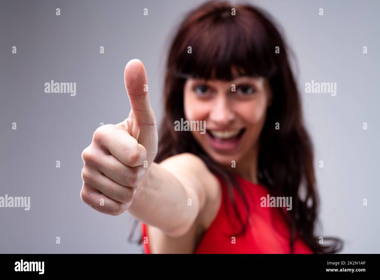 Motivated young woman giving a thumbs up Stock Photo - Alamy Motivated young woman giving a thumbs up Stock Photo - Alamy