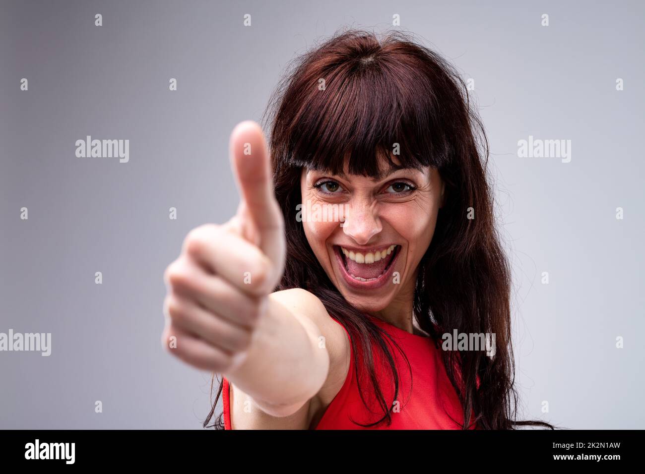 Happy enthusiastic woman giving a thumbs up Stock Photo - Alamy Happy enthusiastic woman giving a thumbs up Stock Photo - Alamy