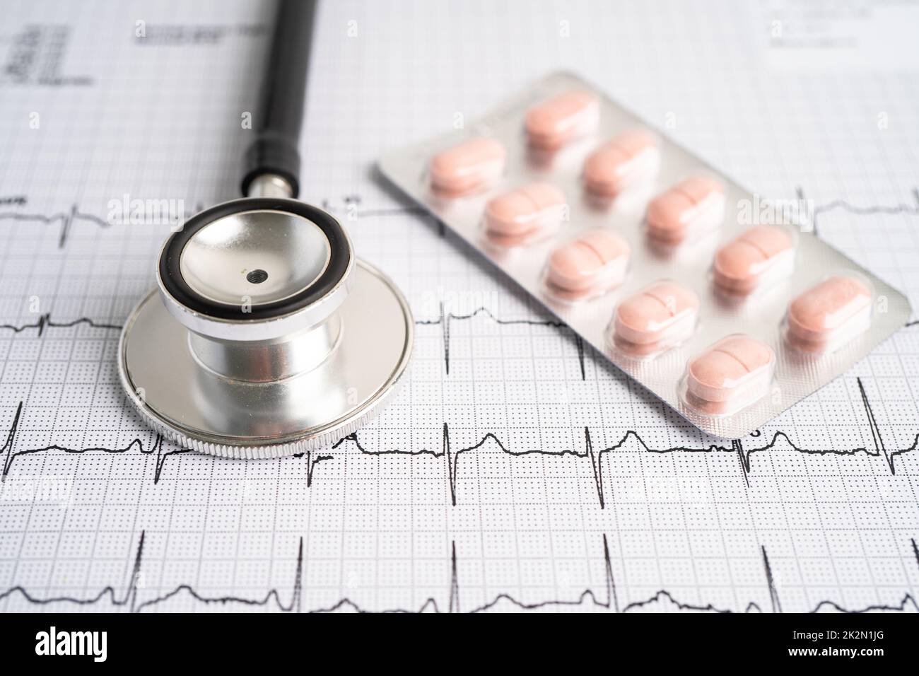 Stethoscope on electrocardiogram with capsule pill, heart wave, heart ...