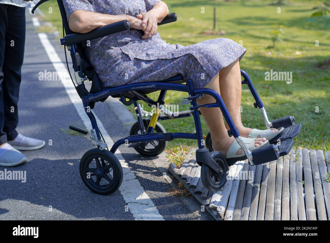 Caregiver help and care Asian senior or elderly old lady woman patient ...