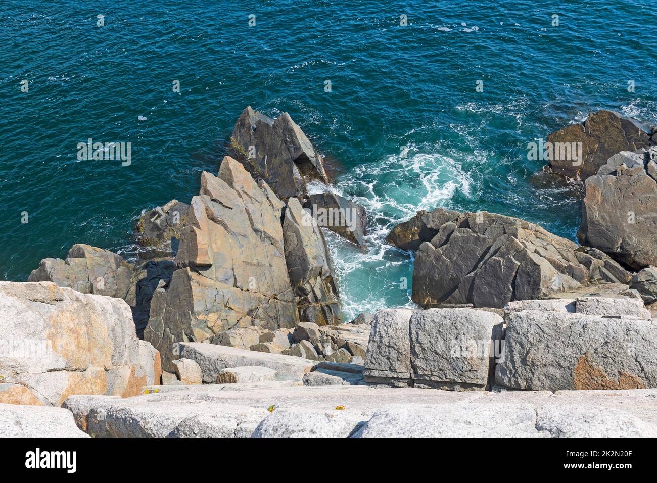 Jagged Rocks Below a Steep Ocean Cliff Stock Photo - Alamy