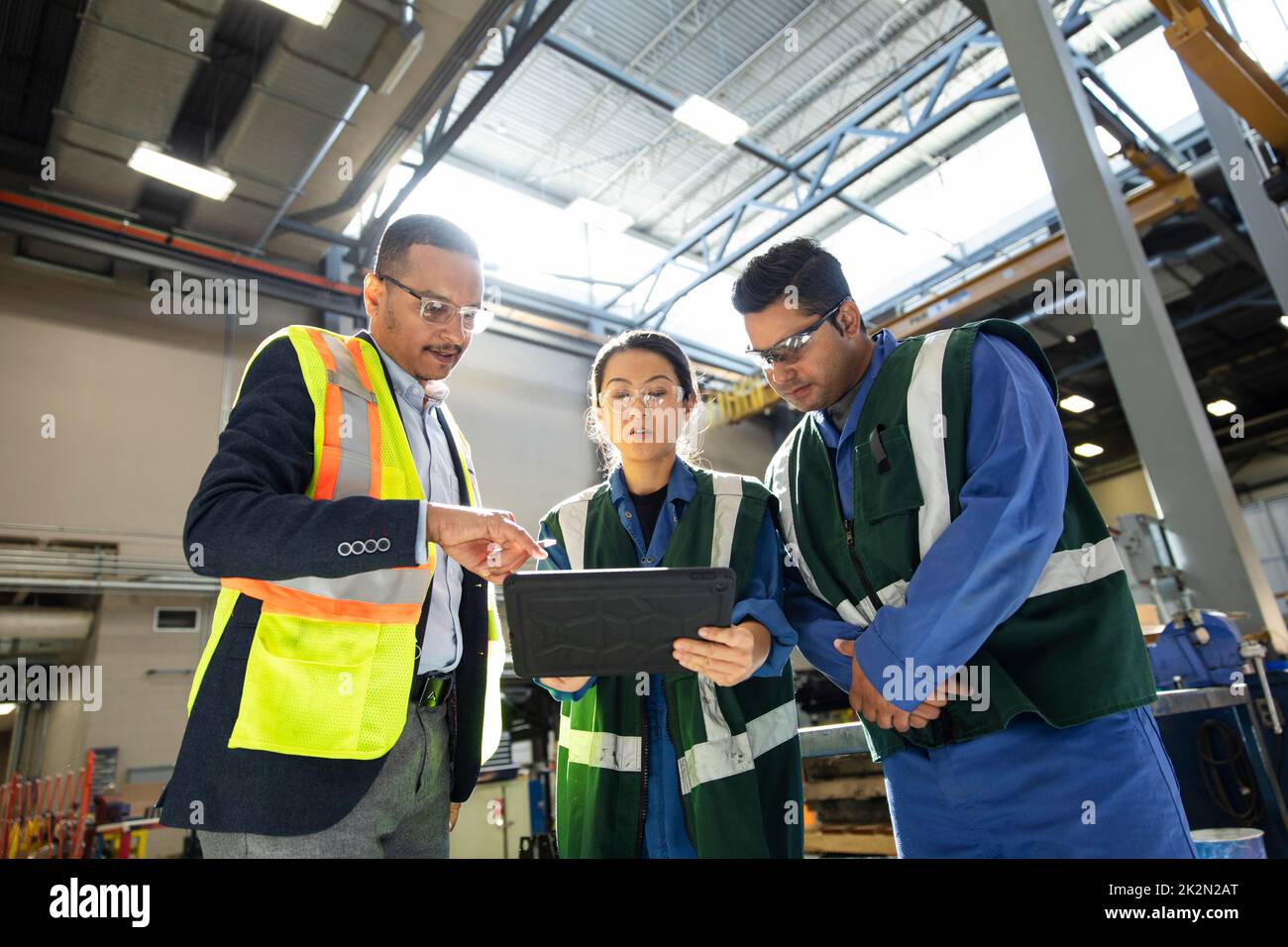 Transit supervisor and workers meeting in maintenance facility Stock ...