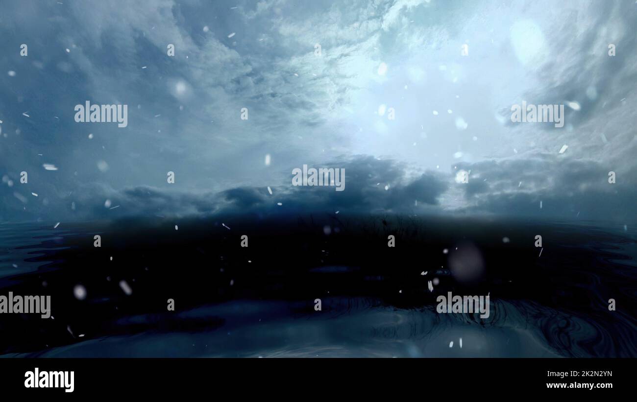 Snowing on Stormy Clouds Over Dark Ocean Stock Photo - Alamy