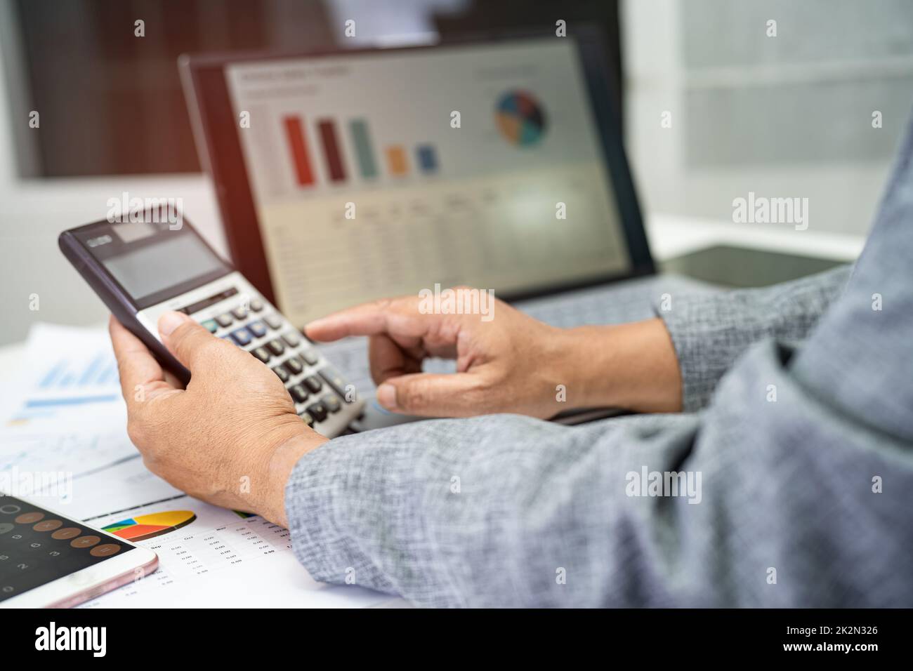 Asian accountant working and analyzing financial reports project ...