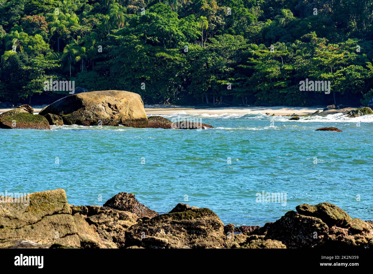 Deserted beach with colorful and transparent waters between the rocks ...