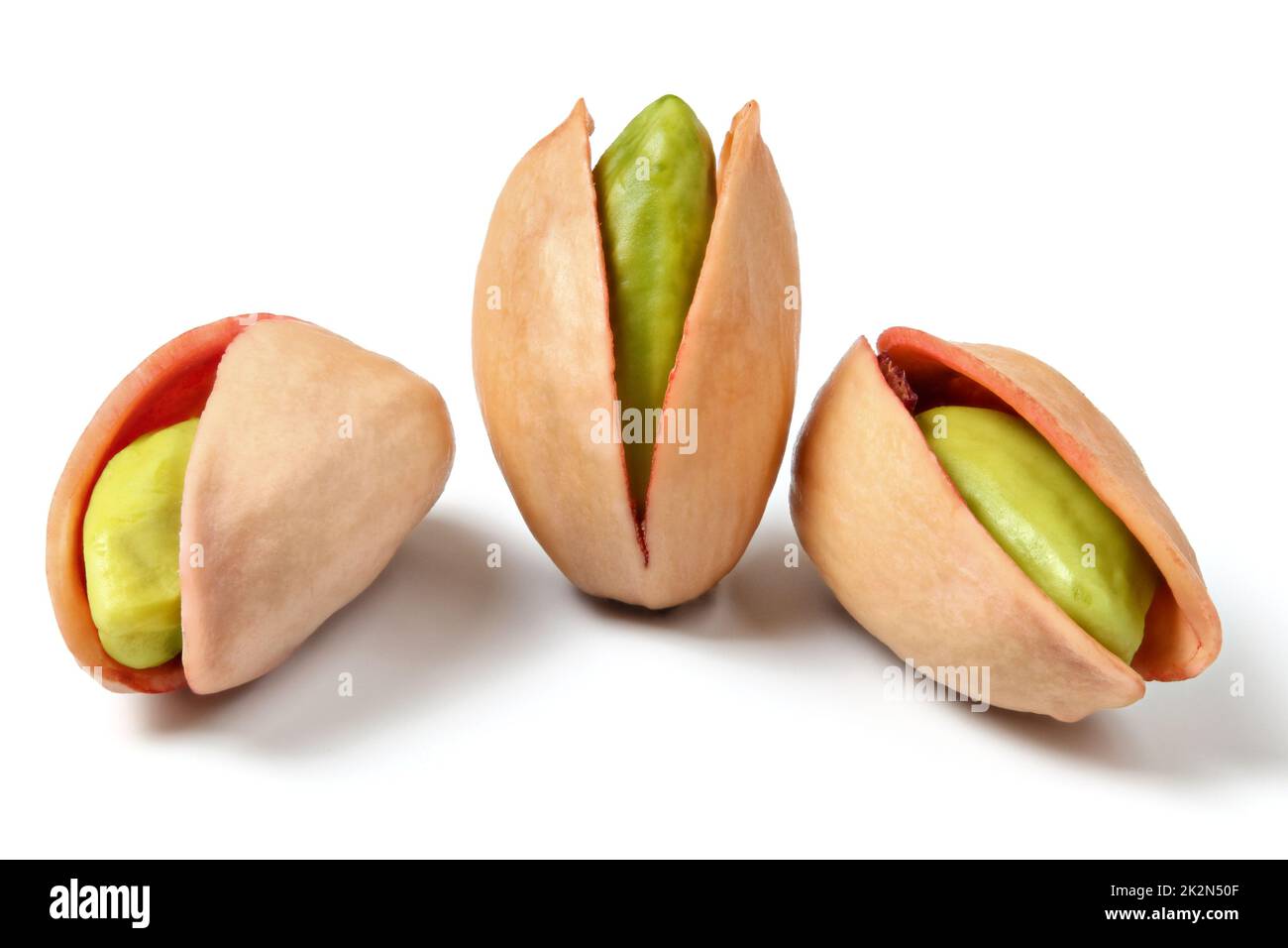 Three turkish red pistachios (Antep Fistigi) peeled green nuts visible ...