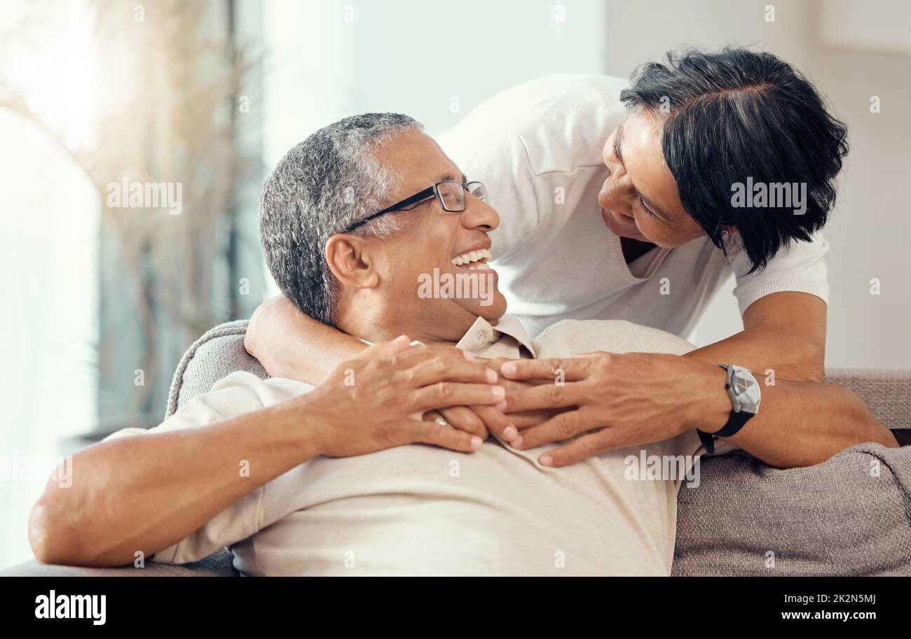 Love, senior couple and hug while laughing, bonding and sharing a romantic moment during ...
