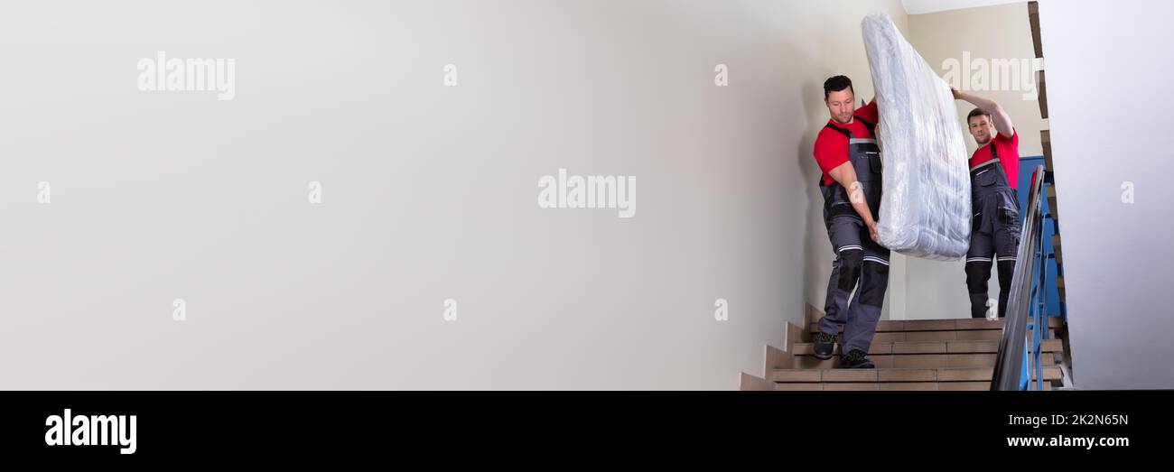 Young Men In Uniform Carrying Mattress Downward Stock Photo - Alamy