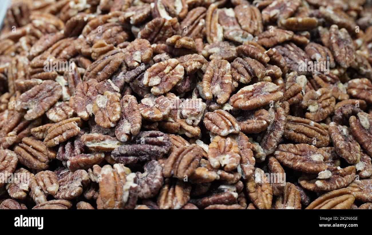 Raw English walnut nuts for sale at local city market. Pile of peeled ...