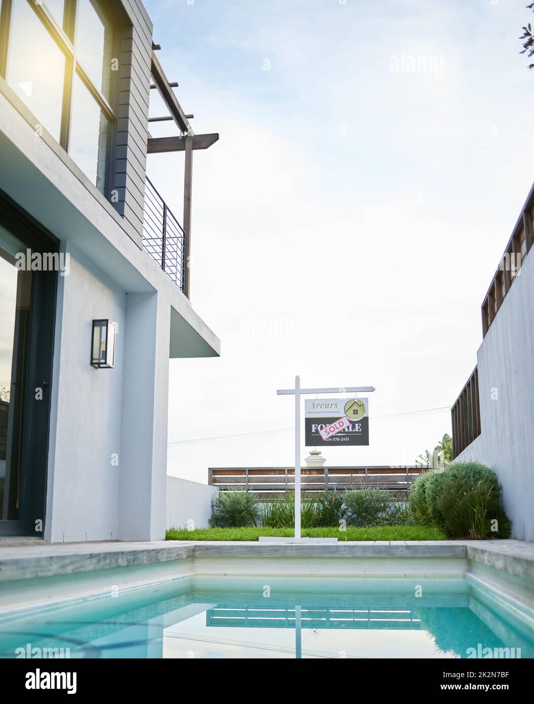 Its officially sold. Shot of a sold sign in a yard of a newly bought ...