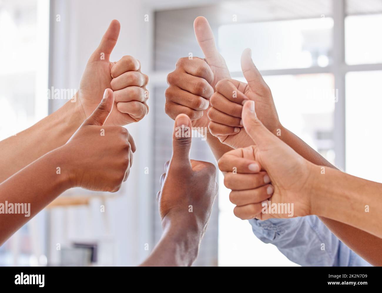 Thumbs up for teamwork. Cropped shot of a group of unrecognizable ...